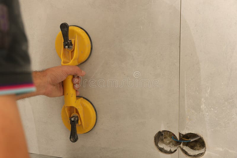 Worker Installing Wall Tiles with Vacuum Holder, Closeup Stock Photo ...