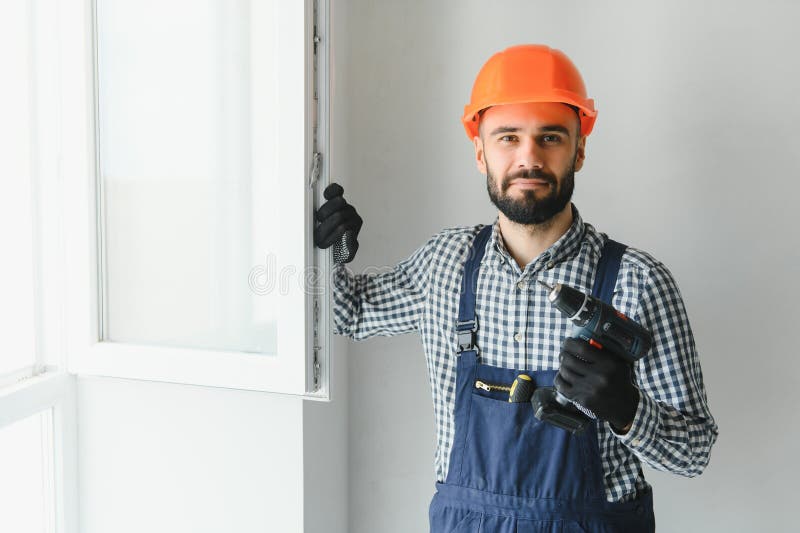 Worker in Installing White Plastic Upvc Window on House. Stock Image ...