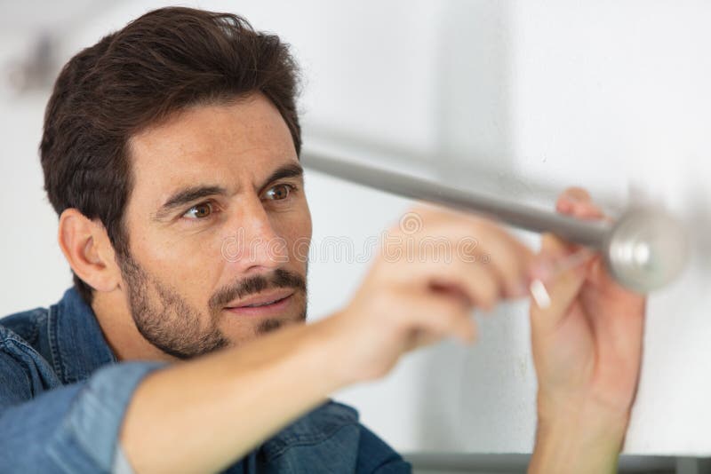 Worker Installing Window Curtain Rod on Wall Stock Photo - Image of ...