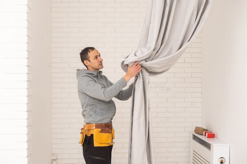 Worker Installing Window Curtain Rod on the Wall. Stock Photo - Image ...
