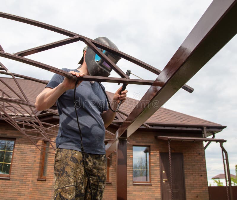 The Worker Installs the Metal on the Canopy. Stock Image - Image of ...