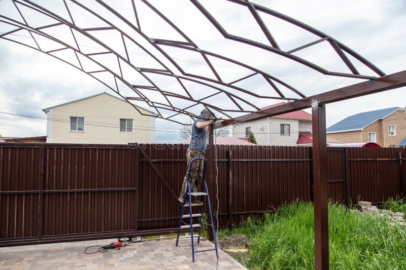 The Worker Installs the Metal on the Canopy. Stock Photo - Image of ...