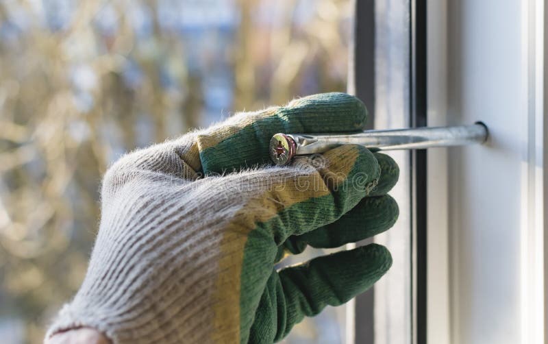 A Worker Installs a New Plastic Window on the Anchors Stock ...
