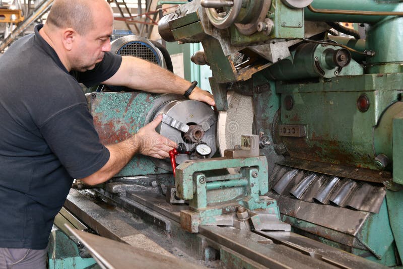 The Worker Installs the Part in the Chuck of the Grinding Machine for ...