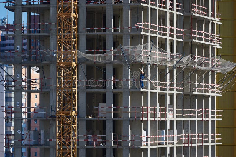 A Worker Installs Safety Nets at a Construction Site Stock Image ...