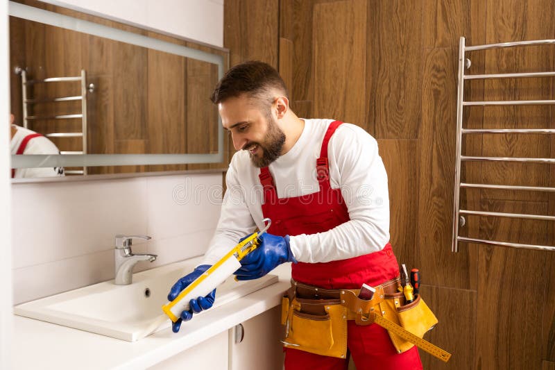 A Worker Installs a Wash Basin in a Bathroom. Stock Photo - Image of ...