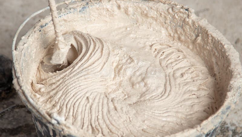 A Worker Kneads the Mixture into Plaster Buckets. Home Renovation Stock ...
