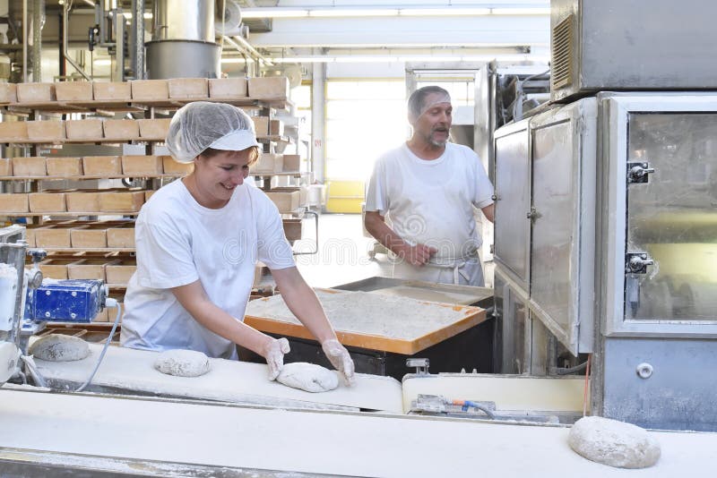 Worker in a Large Bakery - Industrial Production of Bakery Products on ...