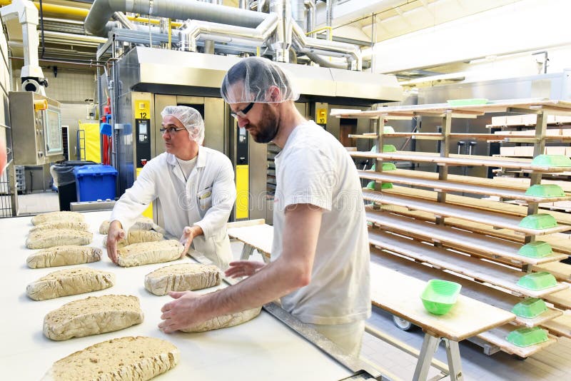 Worker in a Large Bakery - Industrial Production of Bakery Products on ...