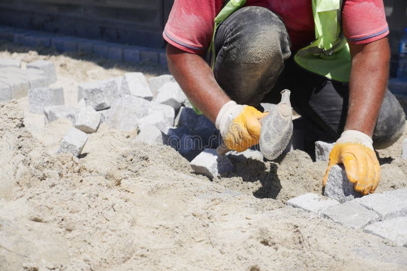 A Worker Laying Concrete Bricks on Each Other for Building a New ...