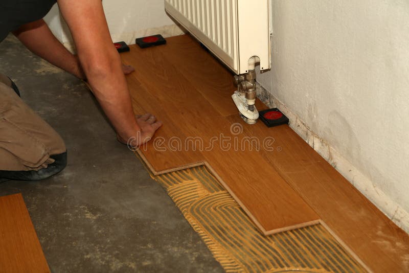 Worker Laying Parquet Flooring. Worker Installing Wooden Laminate ...