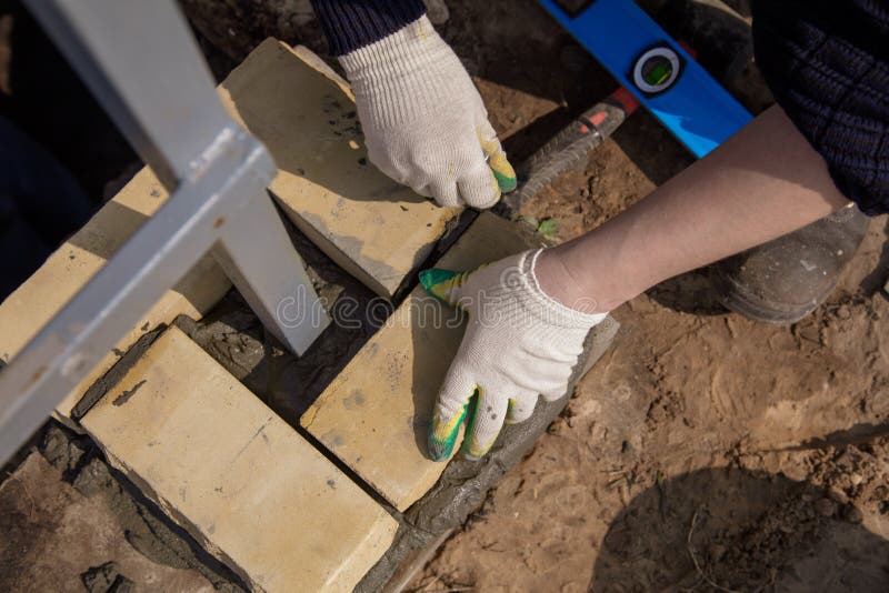 The Worker Lays Bricks on the Construction Site Stock Image - Image of ...