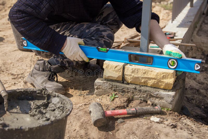 The Worker Lays Bricks on the Construction Site Stock Image - Image of ...