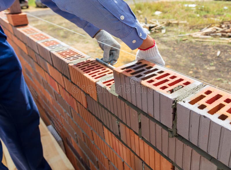 The Worker Lays Bricks on the Wall of the House Stock Photo - Image of ...