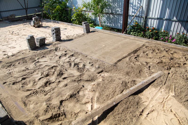 A Worker Lays Down Sand for Paving Slabs. Stock Image - Image of ...