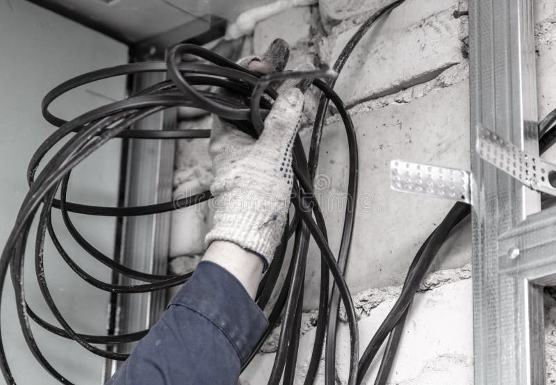 The Worker Lays an Electric Wire Stock Photo - Image of home, repairing ...