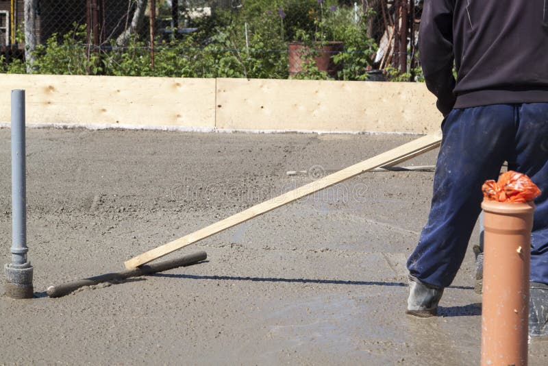 Worker Leveling Fresh Concrete Slab with a Special Working Tool Stock ...