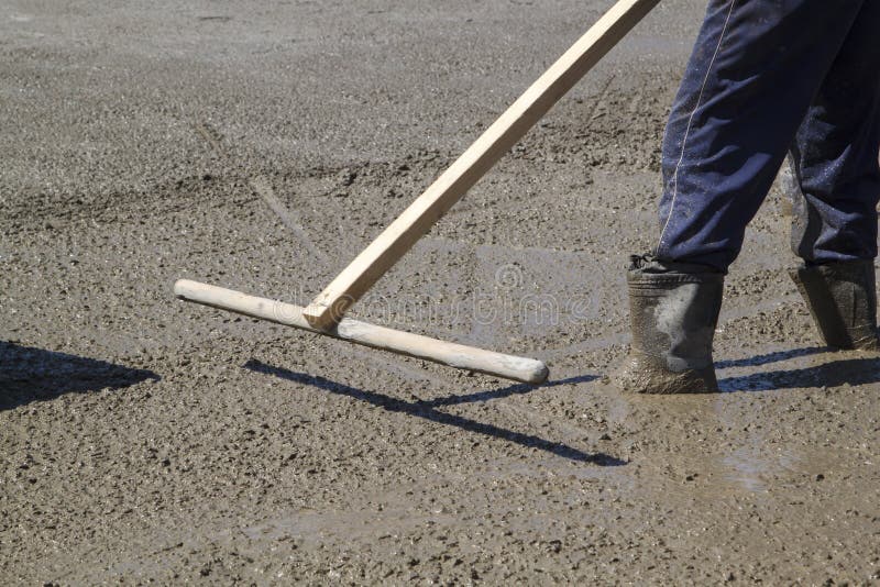 Worker Leveling Fresh Concrete Slab with a Special Working Tool Stock ...
