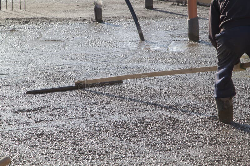Worker Leveling Fresh Concrete Slab with a Special Working Tool Stock ...