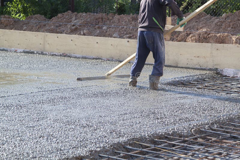 Worker Leveling Fresh Concrete Slab with a Special Working Tool Stock ...