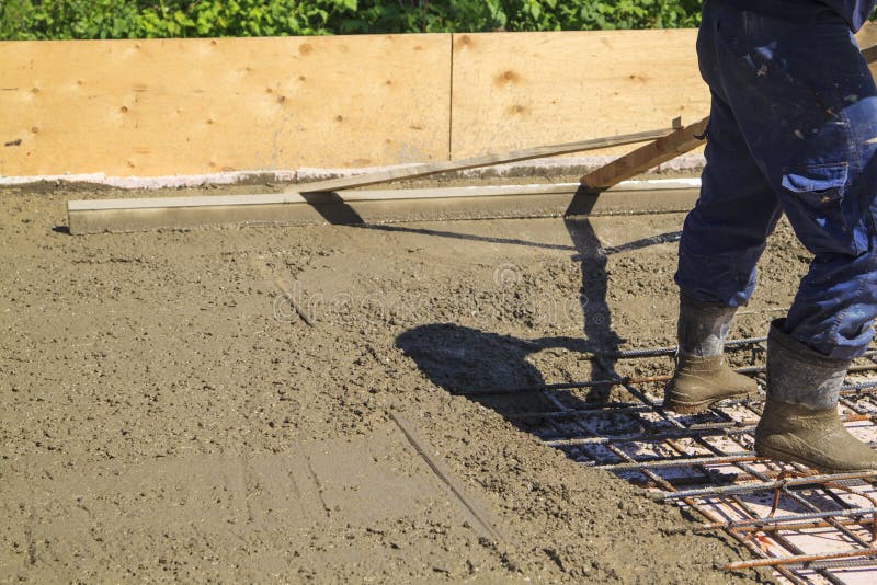 Worker Leveling Fresh Concrete Slab with a Special Working Tool Stock ...