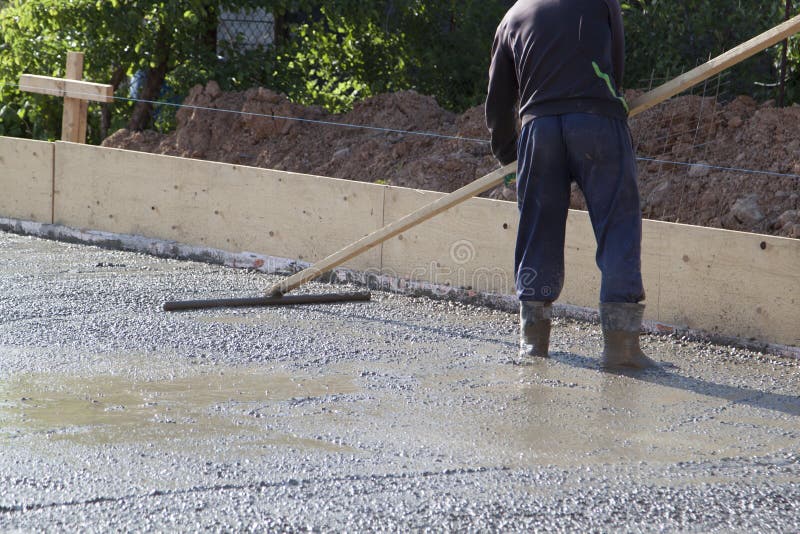Worker Leveling Fresh Concrete Slab with a Special Working Tool Stock ...
