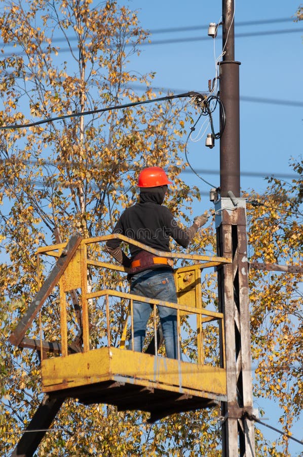 A Worker on a Lifting Platform Paints a Pole Editorial Stock Image ...
