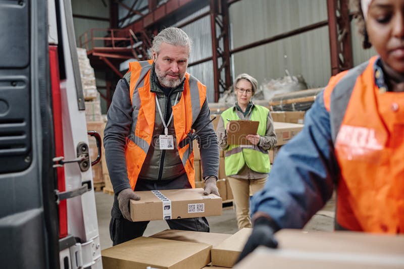 Worker Loading Boxes with His Colleagues Stock Photo - Image of ...