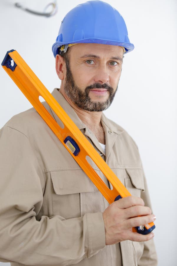Worker Looking at Builders Level Stock Photo - Image of process, male ...