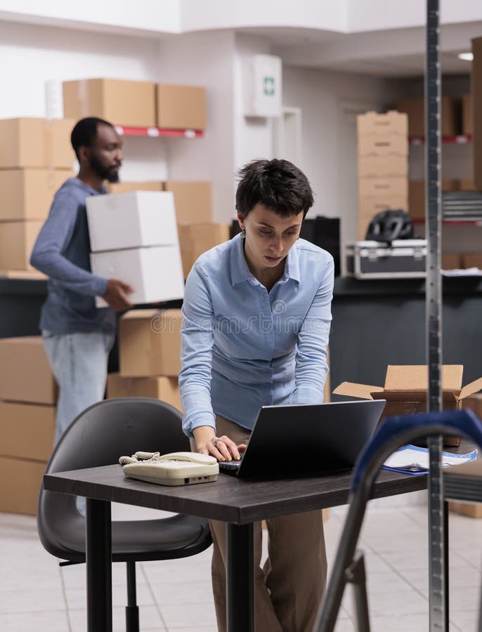 Worker Looking at Cargo Stock on Laptop Computer before Start Preparing ...