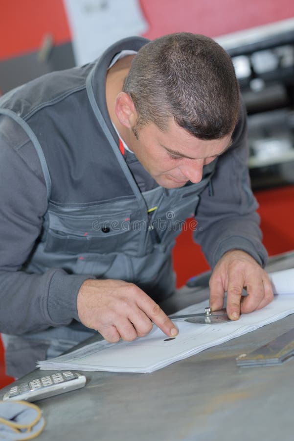 Worker Looking Closely at Paperwork Stock Image - Image of factory ...