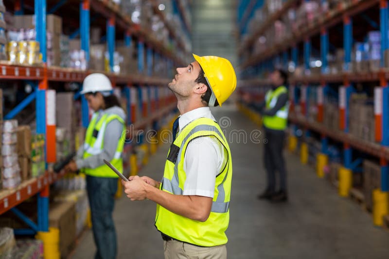 Worker Looking Up in Warehouse Stock Photo - Image of helmet, coworkers ...