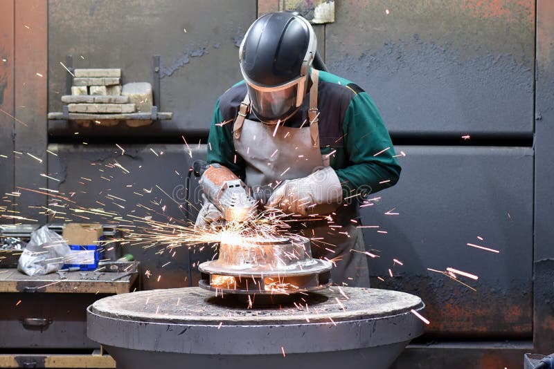Worker with a Grinding Machine Processes a Gear Wheel - Production of ...