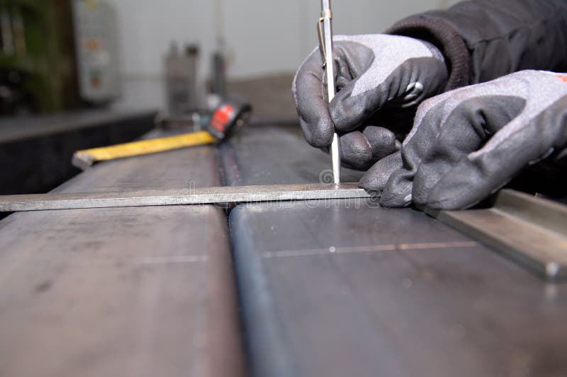 Worker Makes a Mark on Metal Surface. Drilling Holes in Metal Profiles ...