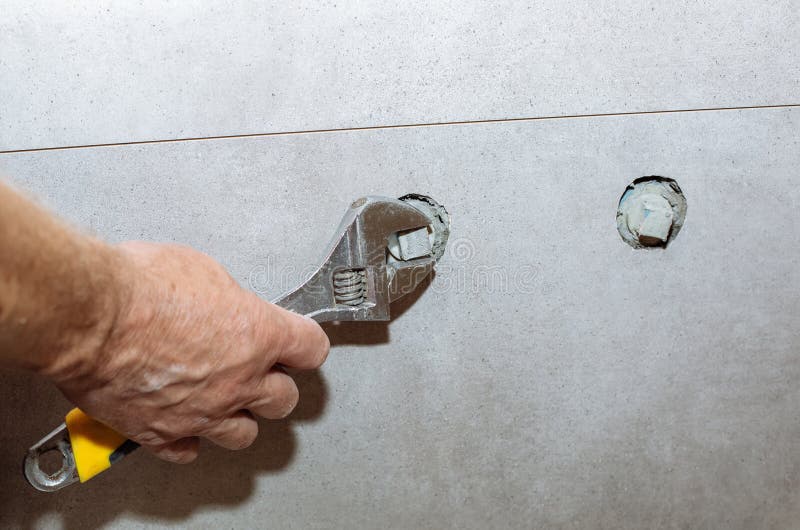 Worker is Making Bath Tap Installation. Maintenance Repair in the Flat ...