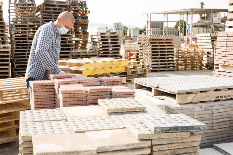 Worker Man Face Mask Holding Stack Paving Slabs Stock Photos - Free ...