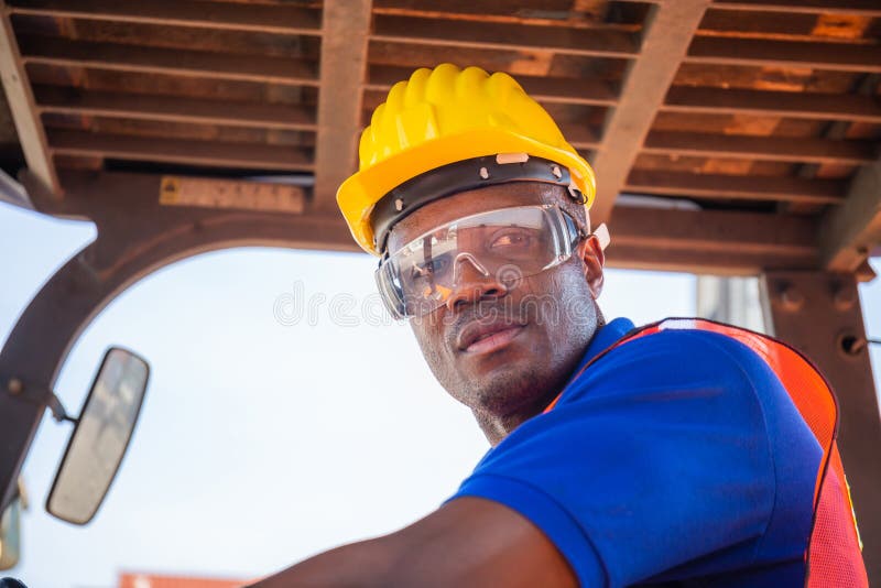 Worker Man in Hardhat and Safety Vest Sitting in Container Stackers ...
