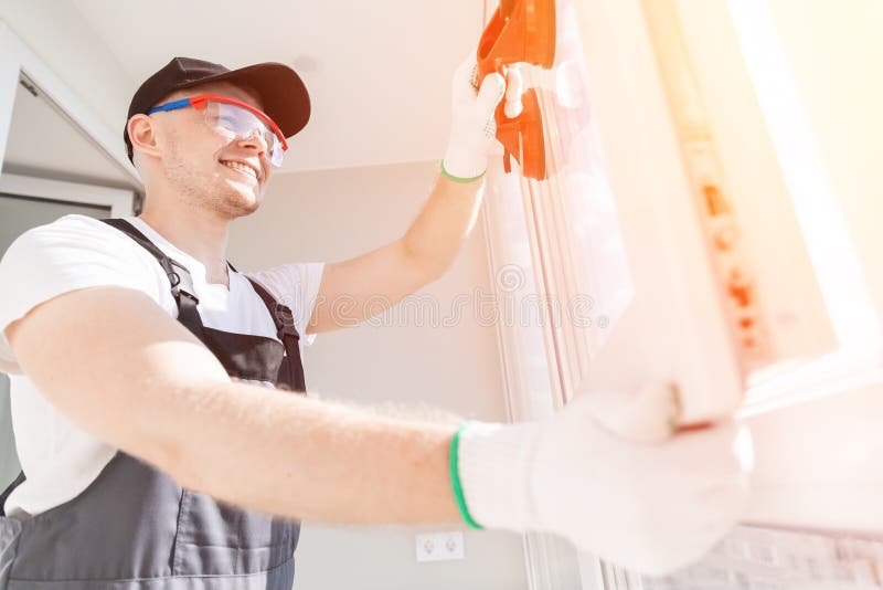 Worker Man Installs Plastic Windows and Doors with Double-glazed White ...