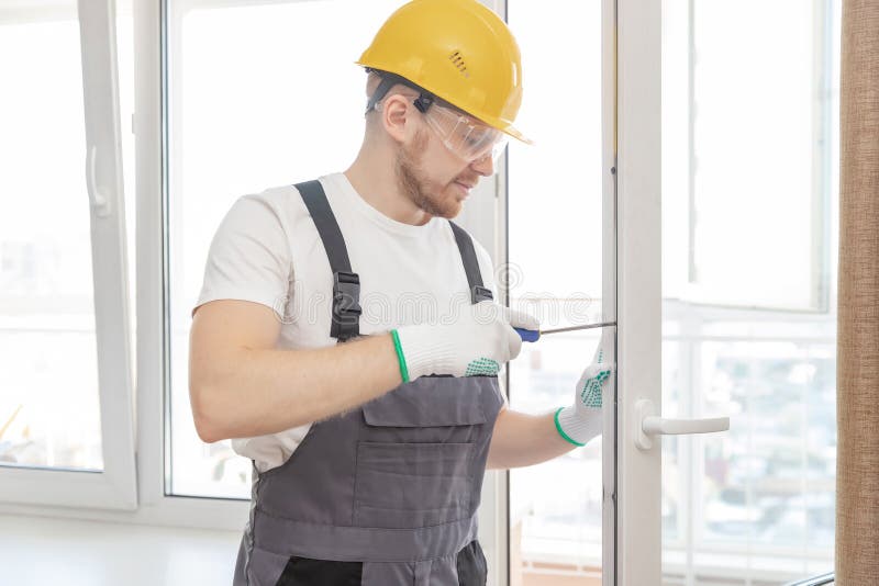 Worker Man Installs Plastic Windows White Lock and Seal Adjustment ...
