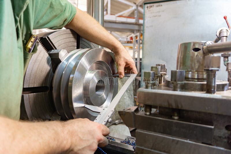 A Worker, a Man Makes Measurements of a Part with a Measuring ...