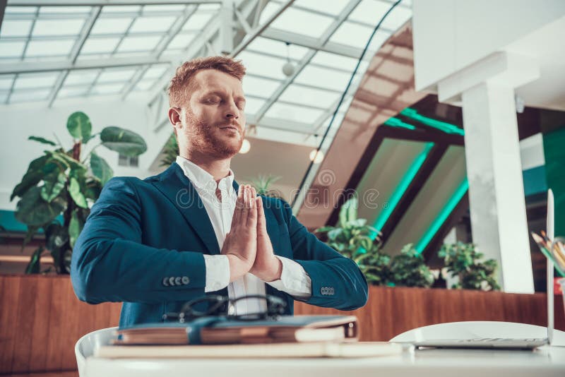 Worker Man Meditating at Desk in Office. Stock Photo - Image of health ...