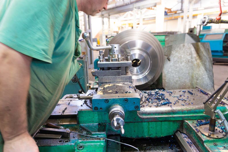 Worker, a Man Processes Metal Products on a Machine. Turning Work in ...
