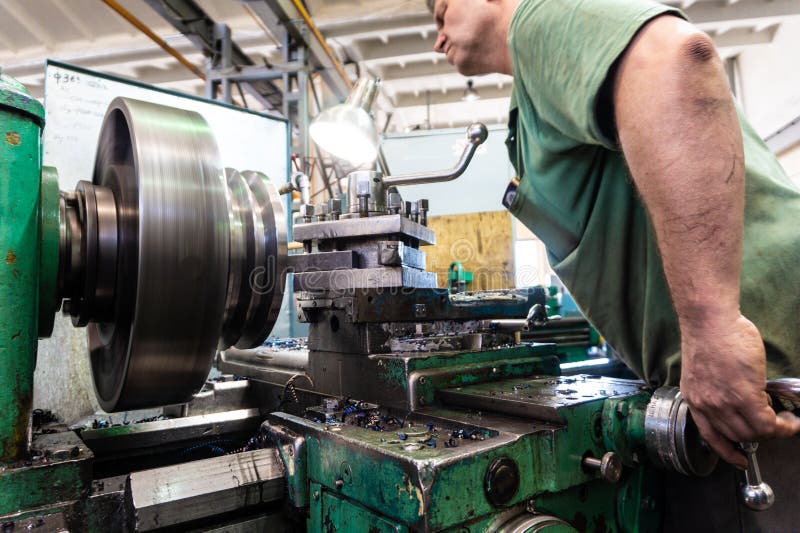 Worker, A Man Processes Metal Products On A Machine. Turning Work In ...