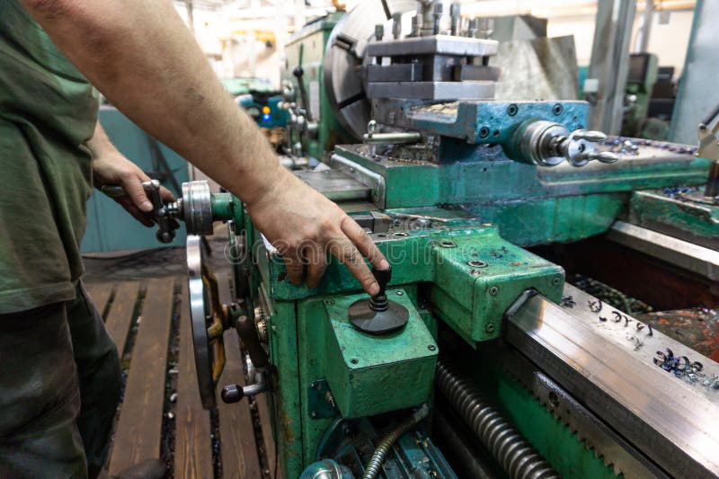 Worker, a Man Processes Metal Products on a Machine. Turning Work in ...