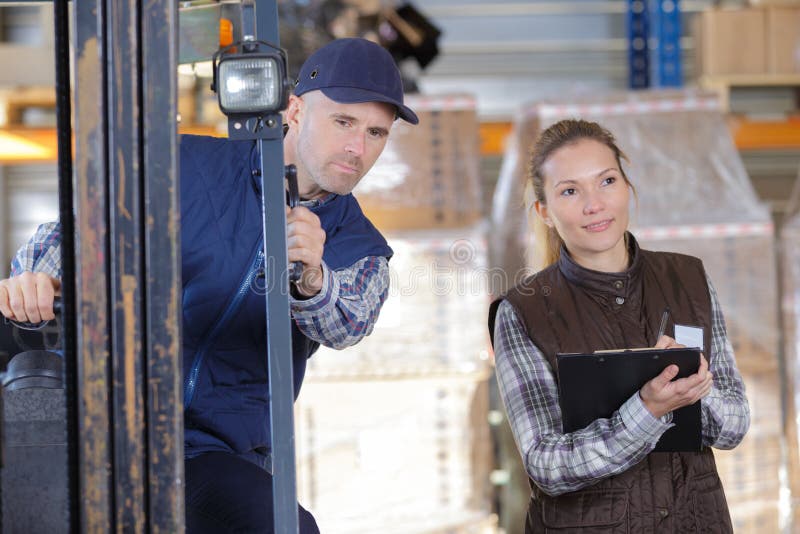Worker and Manager Distributing Goods in Warehouse Stock Photo - Image ...