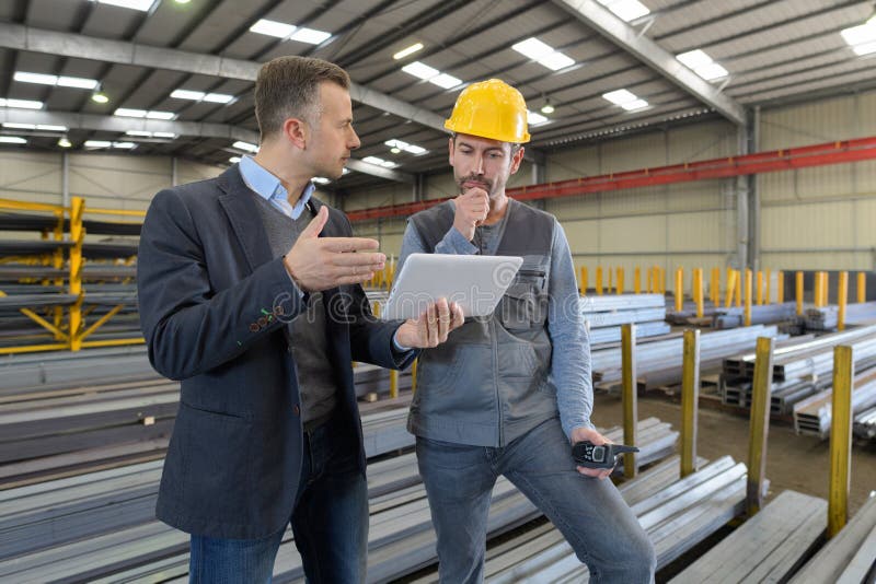 Worker and Manager in Factory Building Stock Photo - Image of overalls ...