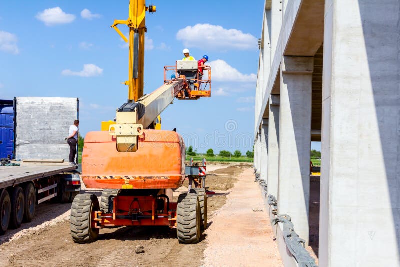 Worker is Managing an Elevated Cherry Picker at Building Site Editorial ...