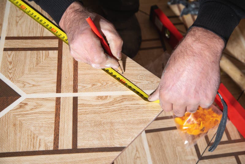Worker Marking Ceramic Tile with Pencil and Measuring Tape Stock Image ...