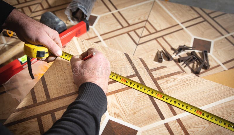 Worker Marking Ceramic Tile with Pencil and Measuring Tape Stock Photo ...