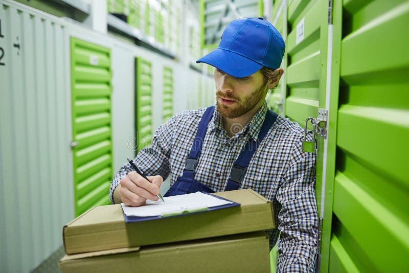 Worker marking the parcel stock image. Image of indoors - 171899489